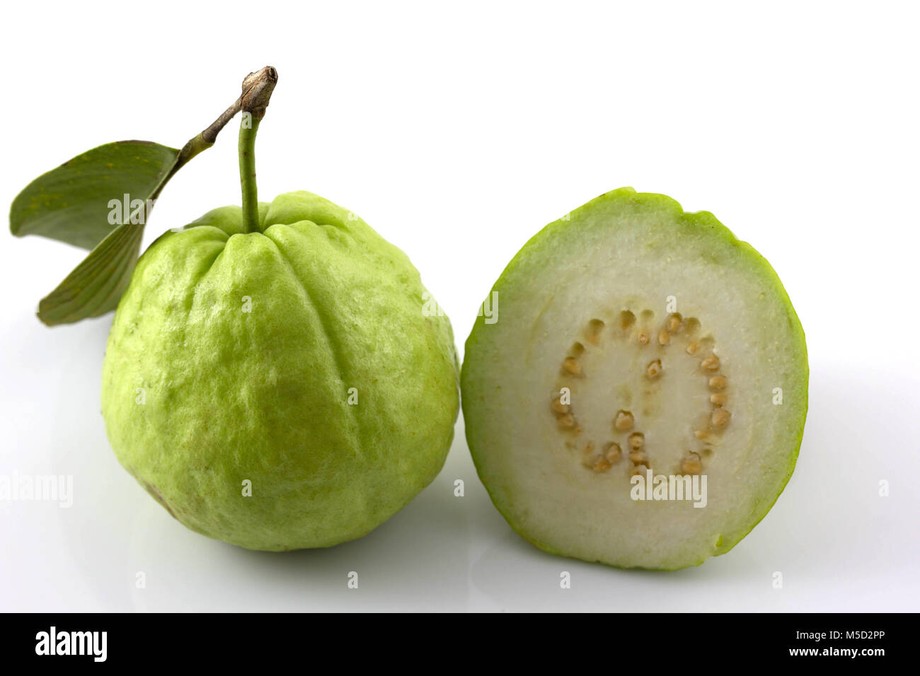 Half guava and slices with the complete one on white background Stock ...