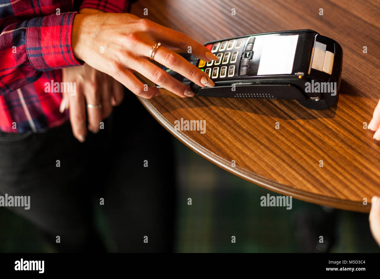 Unseen woman makes bank payment for her business needs Stock Photo - Alamy