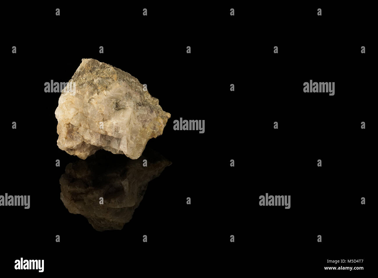 Cassiterite, tin oxide mineral, tin ore isolated on black background ...