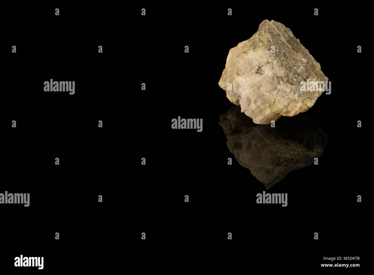 Cassiterite, tin oxide mineral, tin ore isolated on black background ...