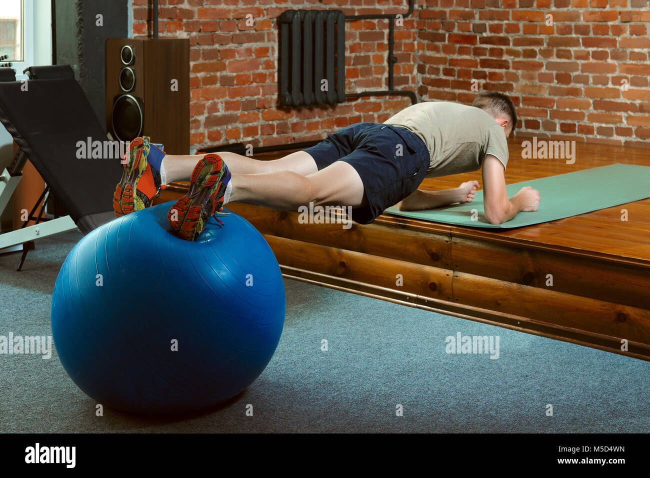 Athletic man doing balancing exercises with the gym ball Stock Photo ...