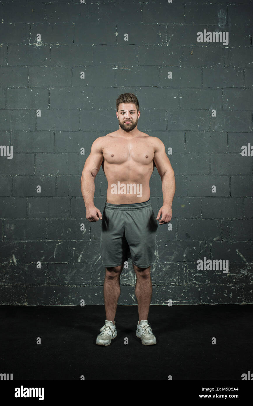 a large weight lifter works out and poses for the camera Stock Photo ...