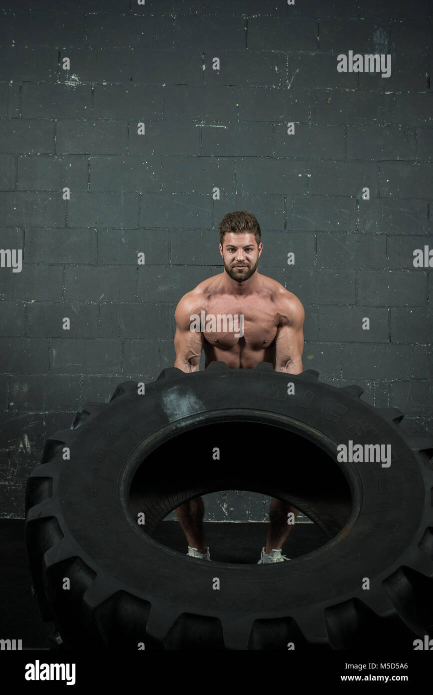 a large weight lifter works out and poses for the camera Stock Photo ...