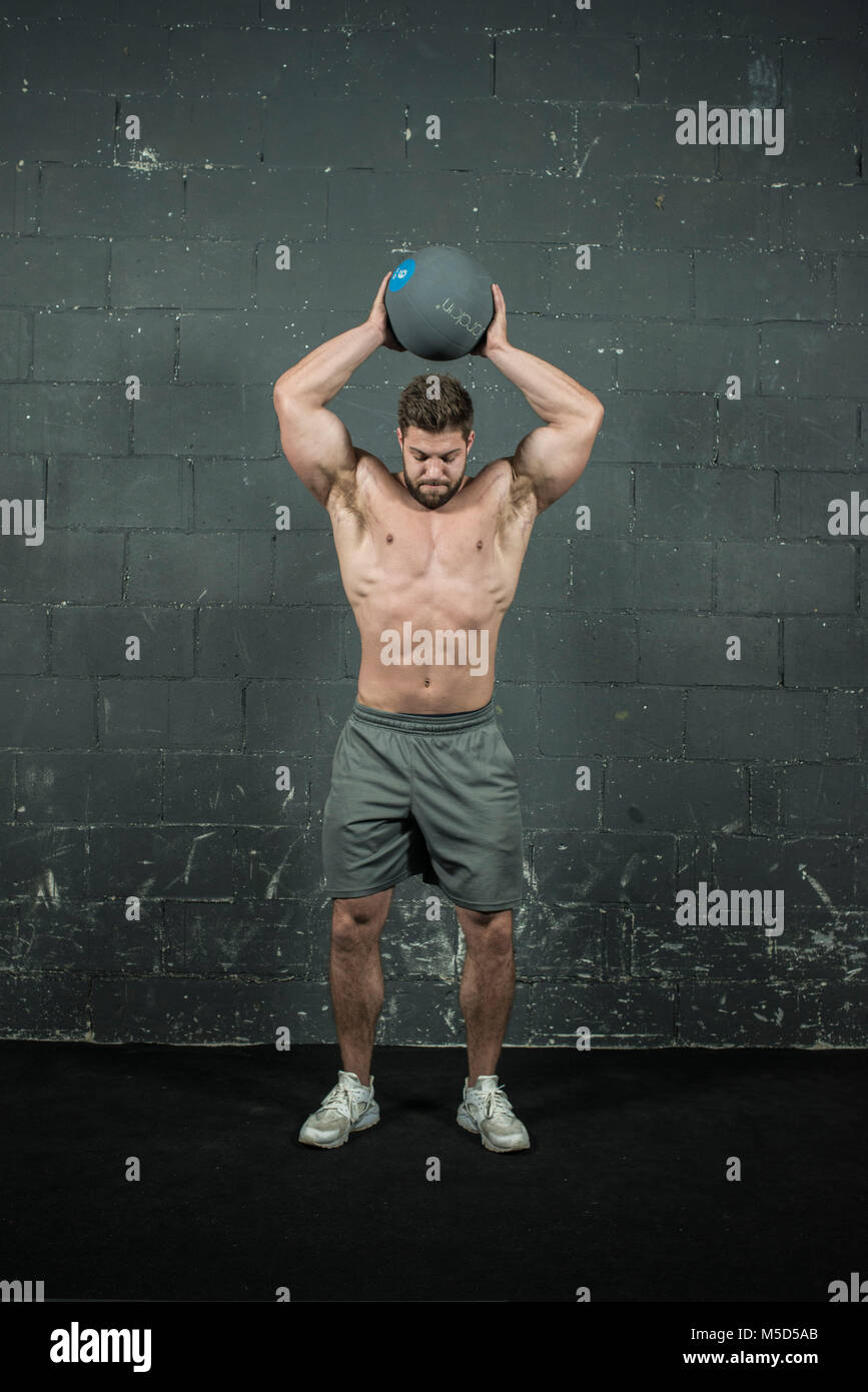 a large weight lifter works out and poses for the camera Stock Photo ...