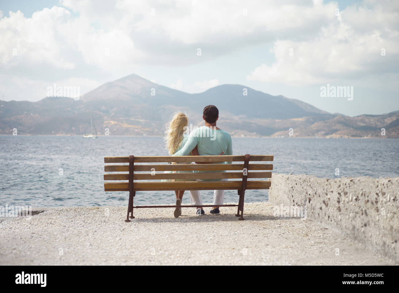 Romantic couple by the sea looking into the distance Stock Photo - Alamy