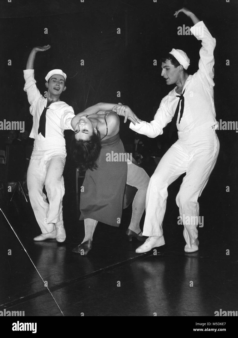 Two sailors dancing with woman in evening gown, 1960s, Berlin, Germany ...