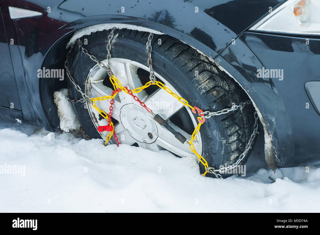 Car with mounted snow chains in wintry environment Stock Photo - Alamy