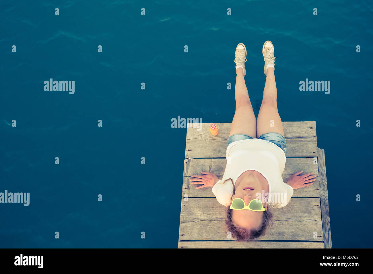 Top view woman sitting on dock hi-res stock photography and images - Alamy