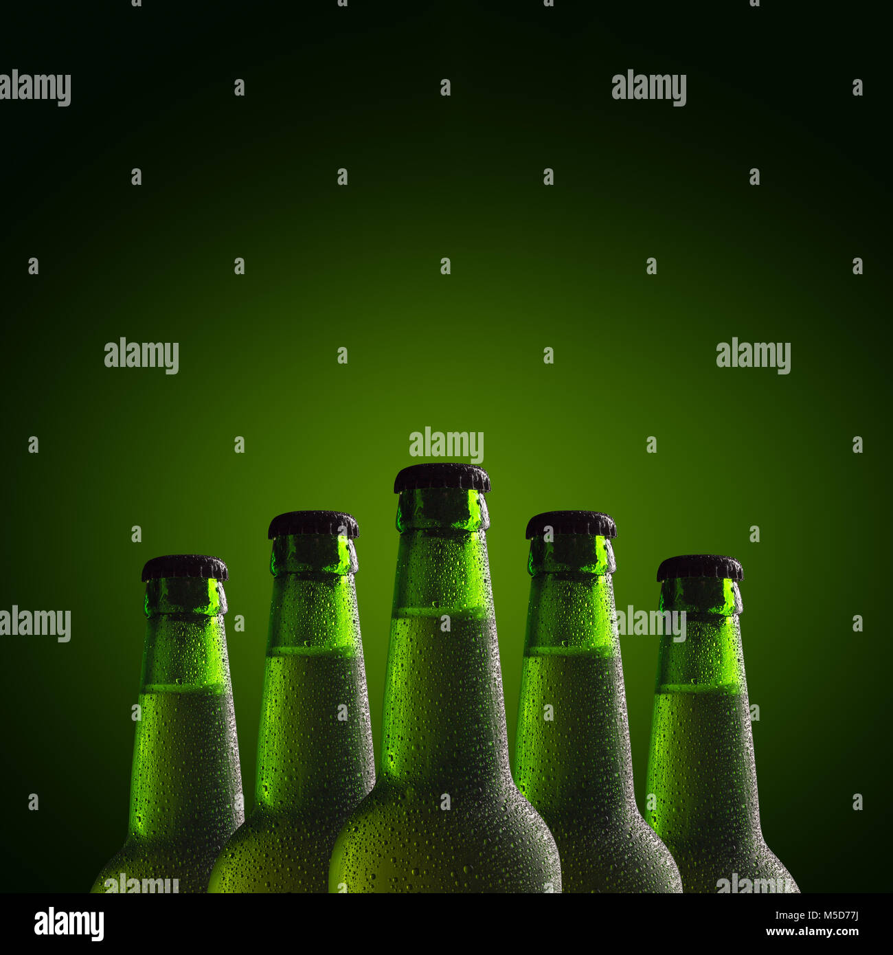 Five Wet Bottles Of Beer Isolated On Green Background Stock Photo - Alamy