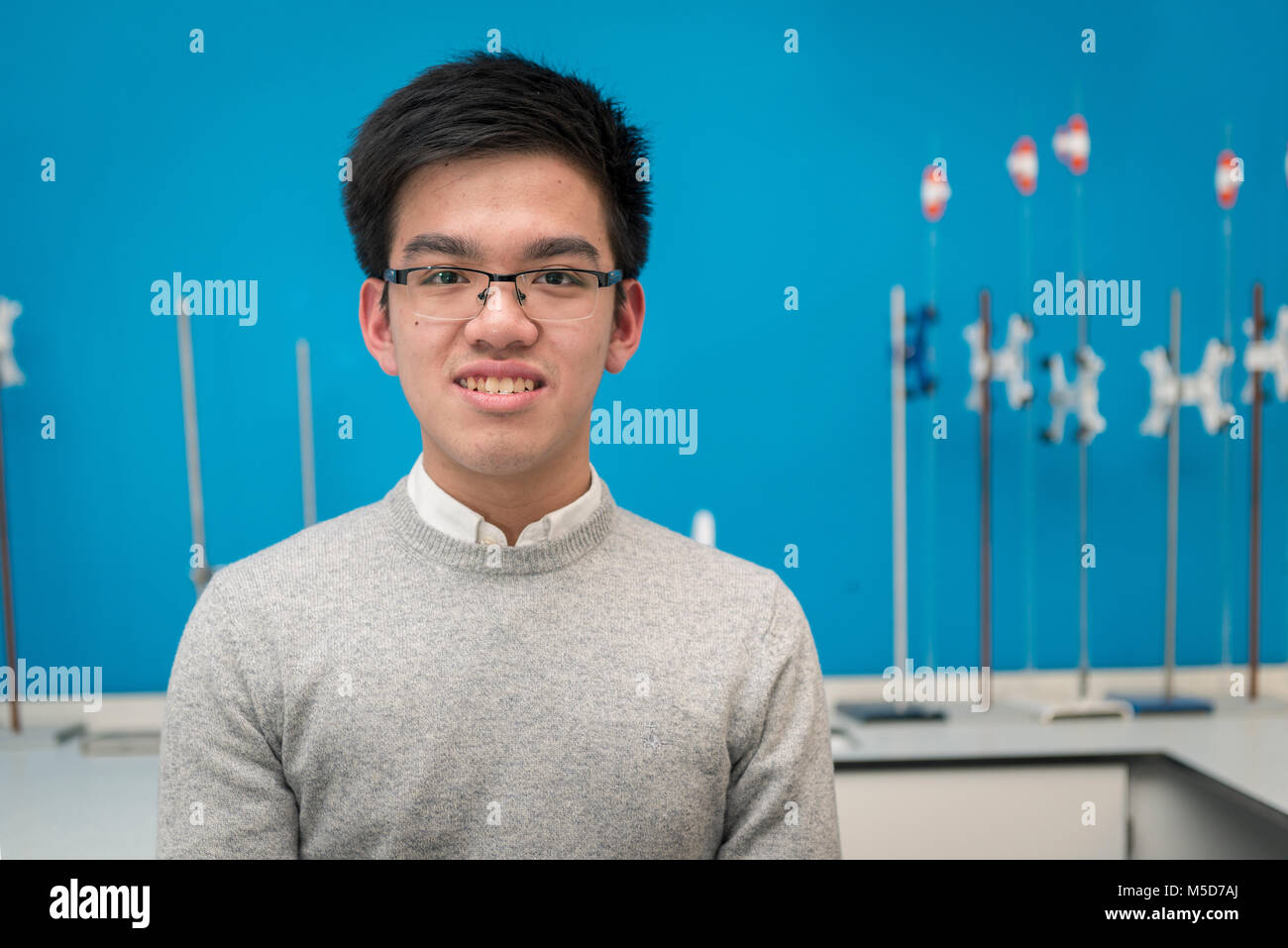 a smart young asian student sits in the science lab of a college Stock ...