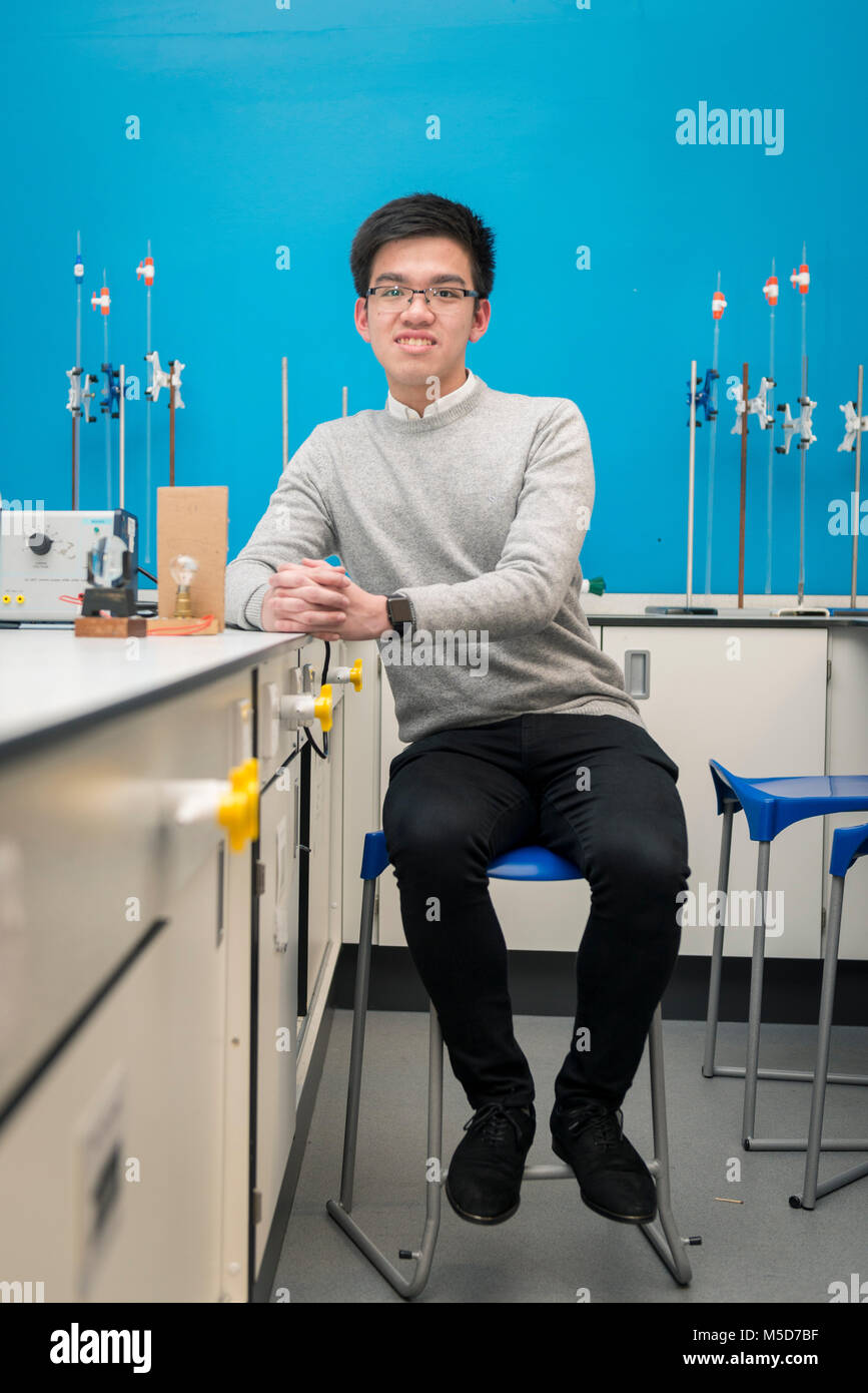 a smart young asian student sits in the science lab of a college Stock ...