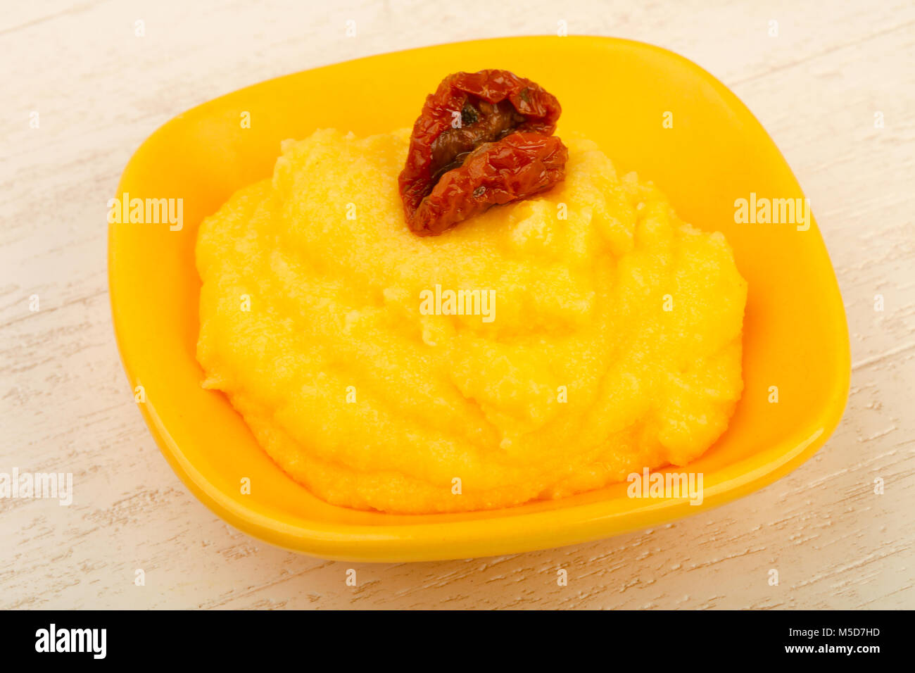Polenta with dry tomato Stock Photo - Alamy