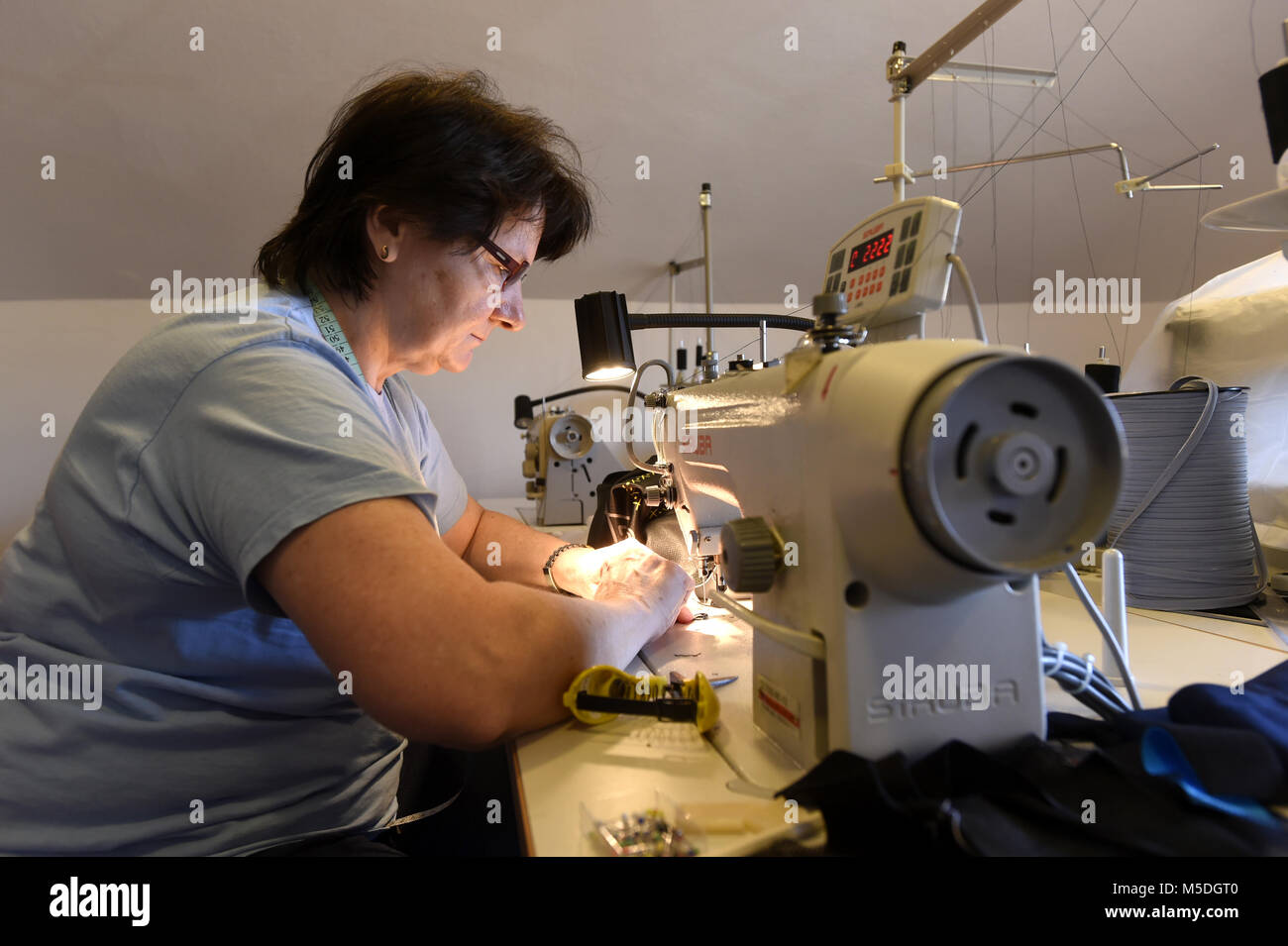 A worker works in Don Quiet, Racing ski clothes and ski suits ...