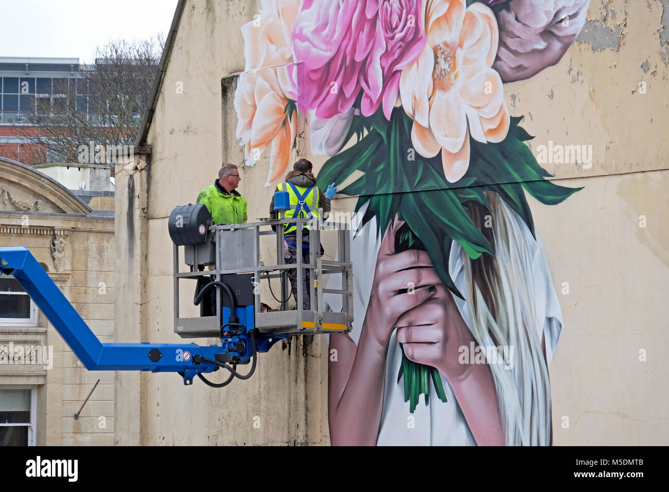 Bristol, UK. 22nd February, 2018. Artist Jody Thomas works on a mural ...