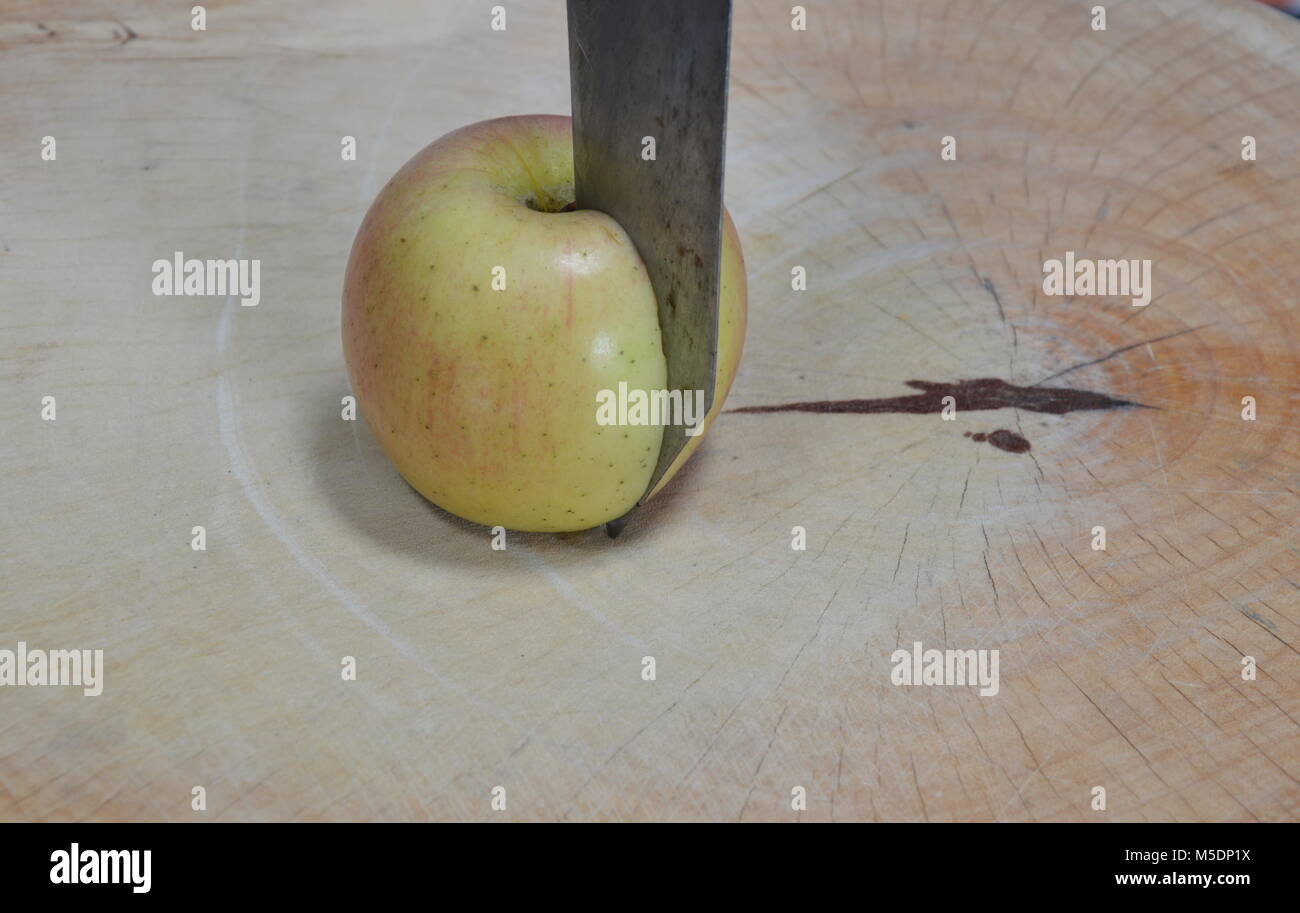 knife cut apple on wooden chop block Stock Photo - Alamy