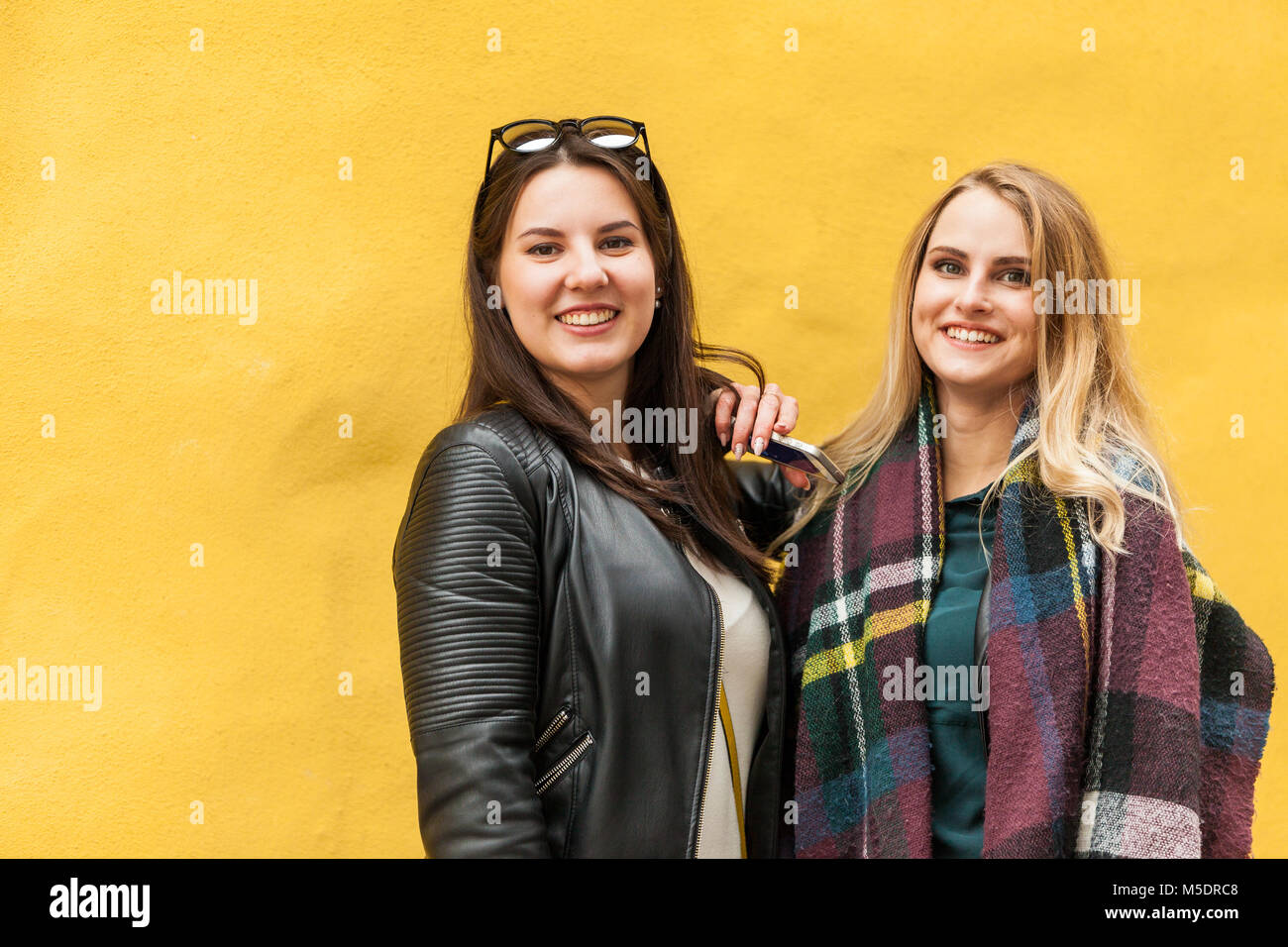 Two beautiful girls looking at camera. Happy smiling Stock Photo - Alamy