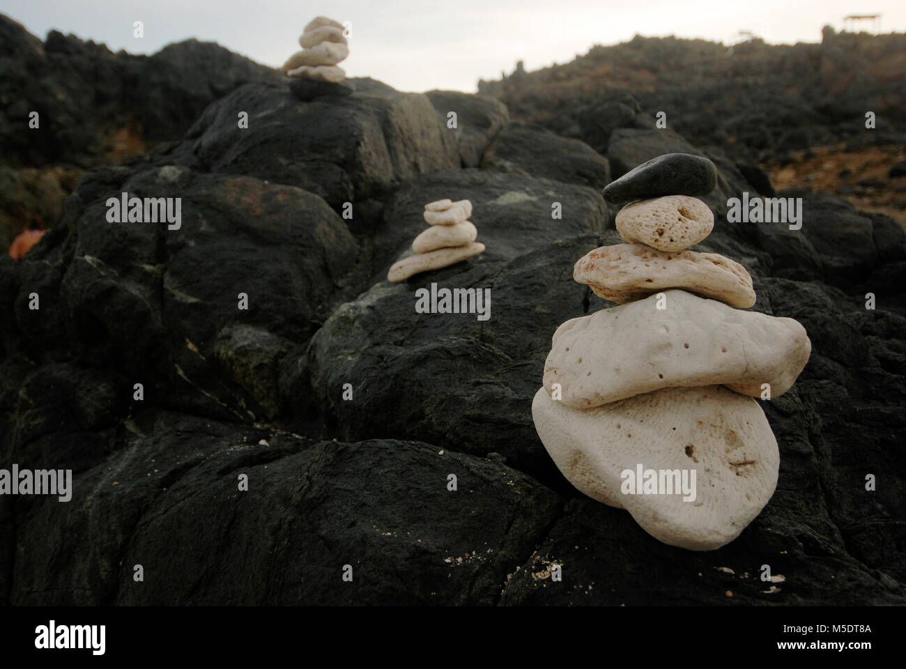 Stacked rocks and shells in Aruba Stock Photo - Alamy