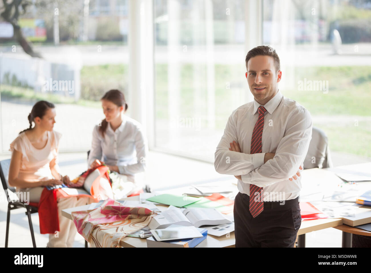 Portrait Of Confident Young Businessman With Female Colleagues In
