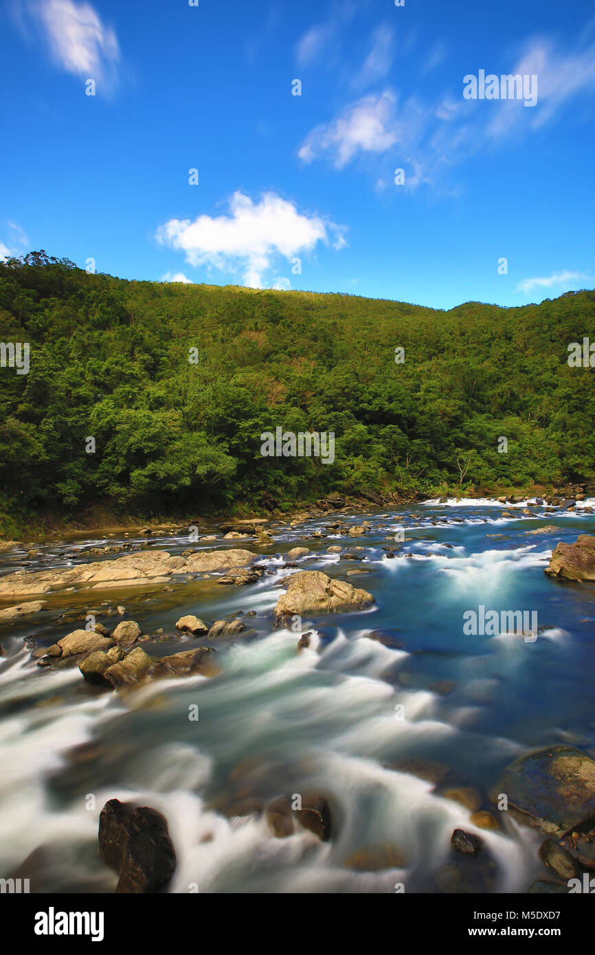 Beautiful flowing river landscape with rocks among the mountains in a ...