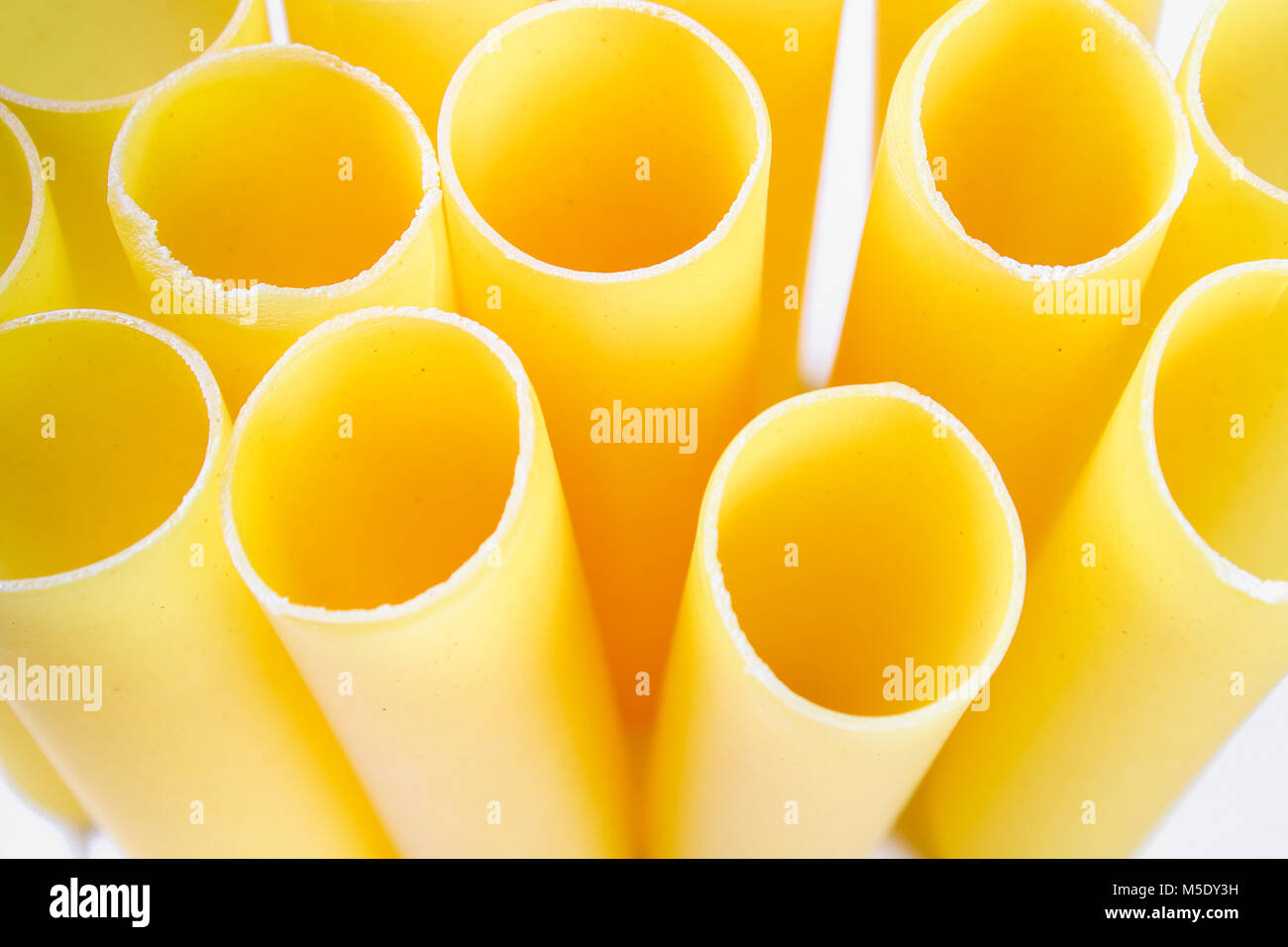 Italian pasta cannelloni. Raw tube for stuffing stuffing surrounded by ...