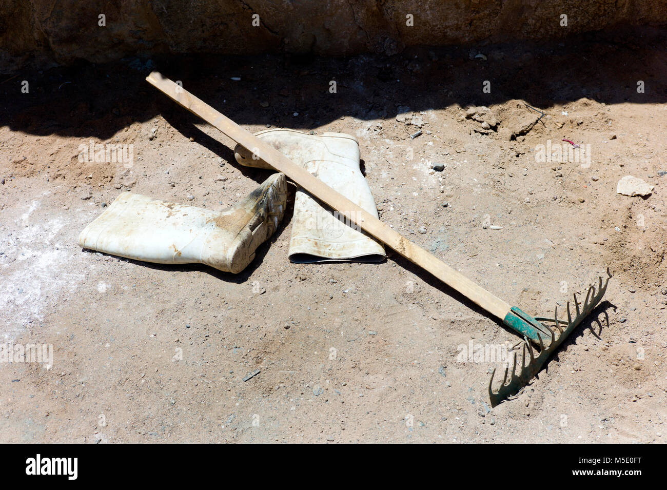 Building site, tools, rakes, wellingtons, mud Stock Photo - Alamy