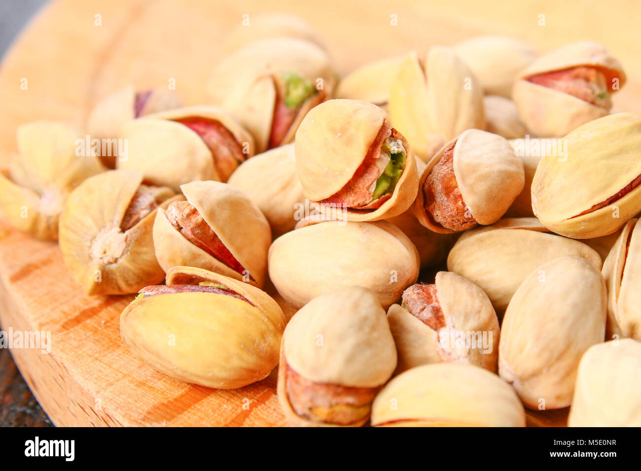 Dish full of pistachios with more pistachios on side Stock Photo - Alamy