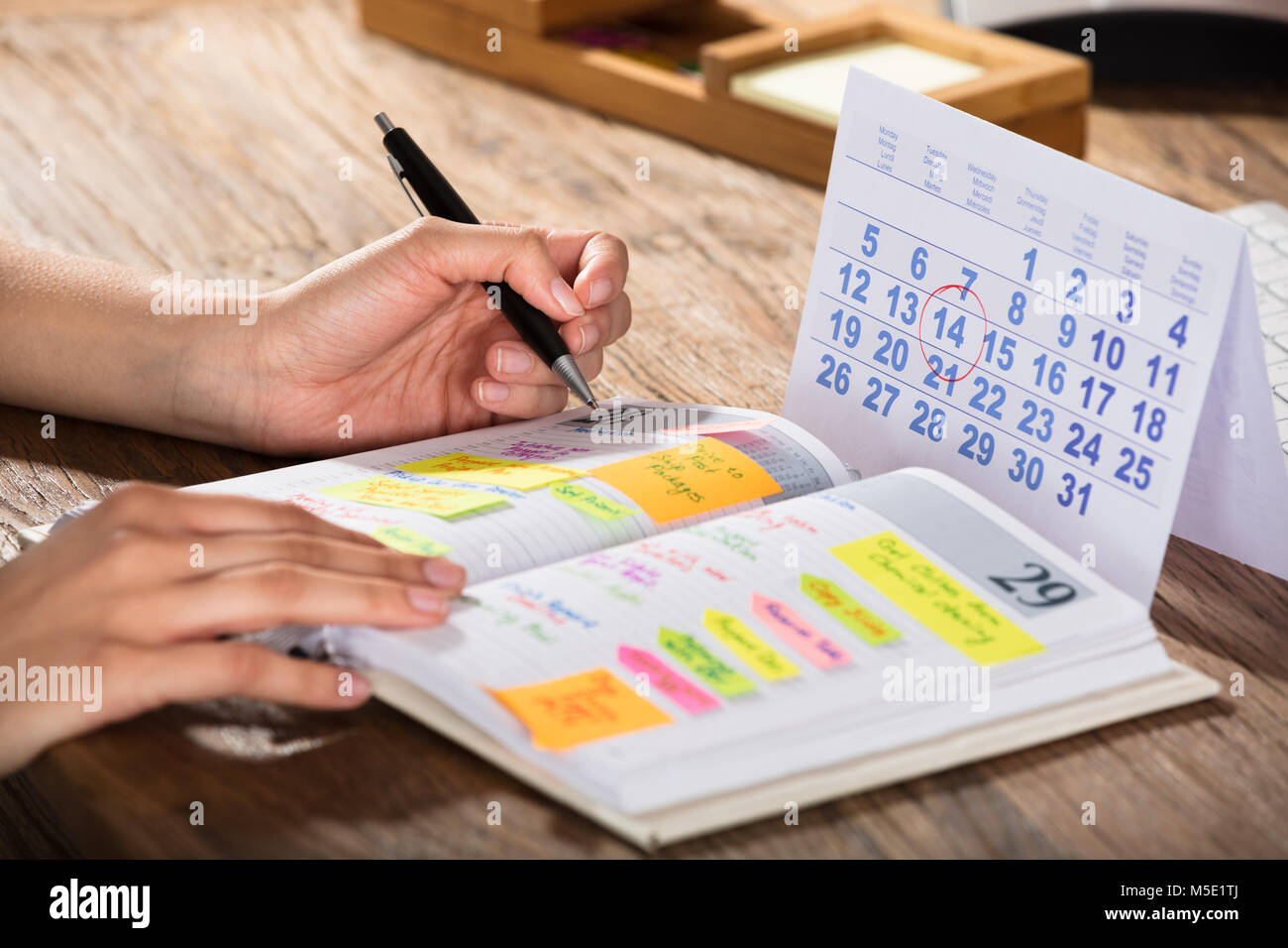 Close-up Of A Businessperson With Calendar Writing Schedule In Diary On ...
