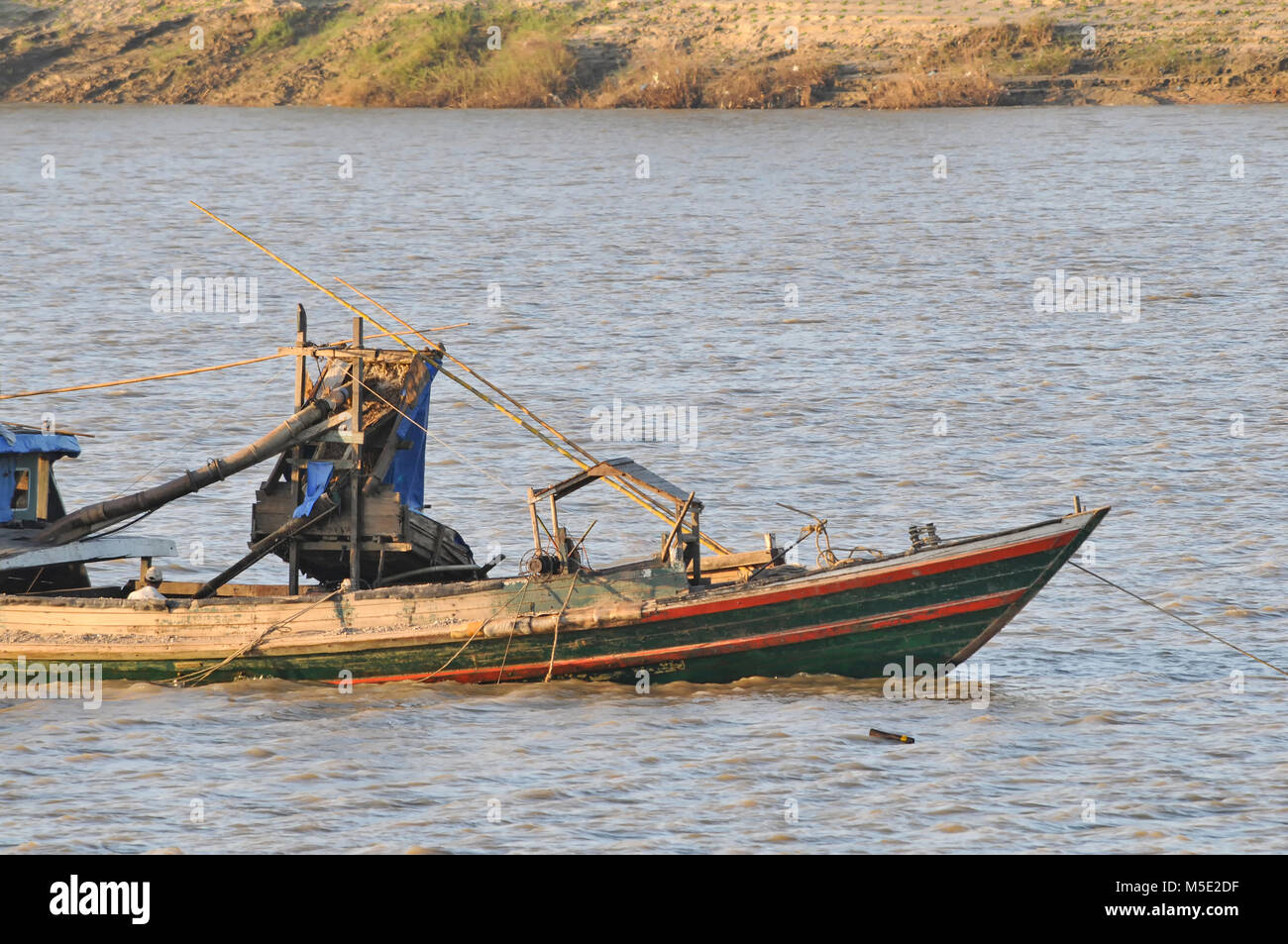 A view of the Irrawaddy River in Myanmar Burma with a fishing boat ...