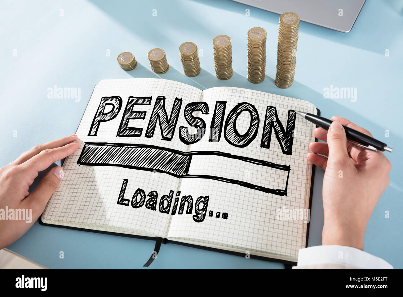 Elevated View Of A Businessperson Drawing Pension Chart On Notebook ...