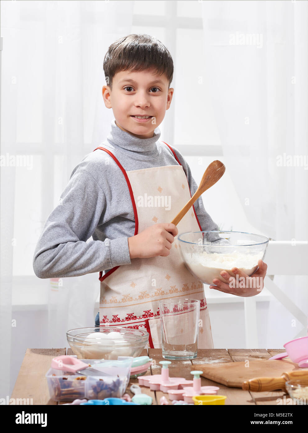 Boy cooking in home kitchen, making dough, healthy food concept Stock ...