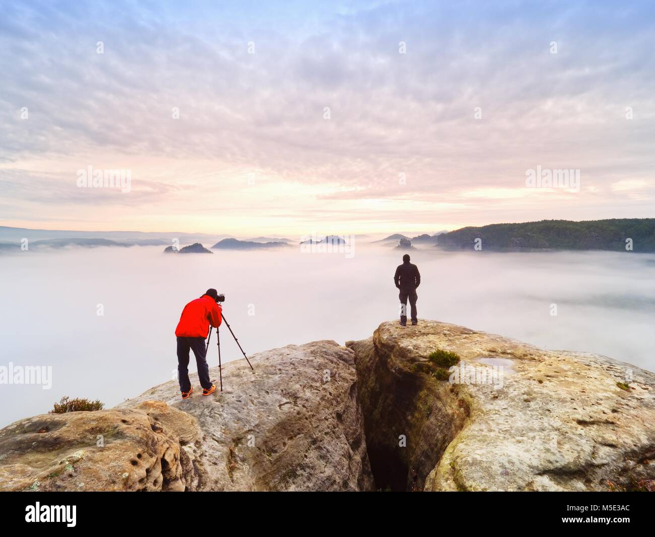 Two men enjoy photographying in wild nature. Nature photographer with ...