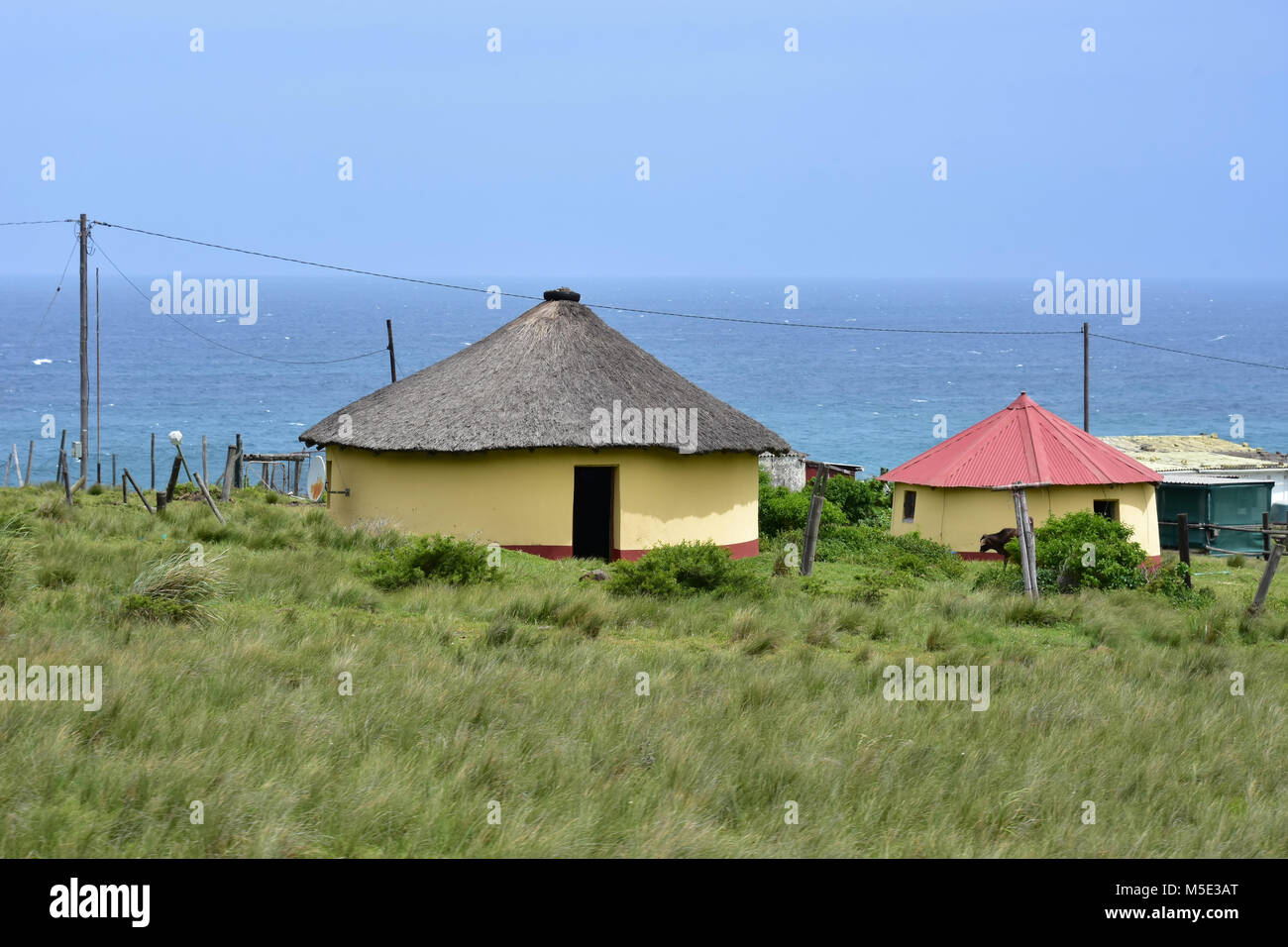 A colorful Xhosa round hut or house or rondavel with thatched roof ...