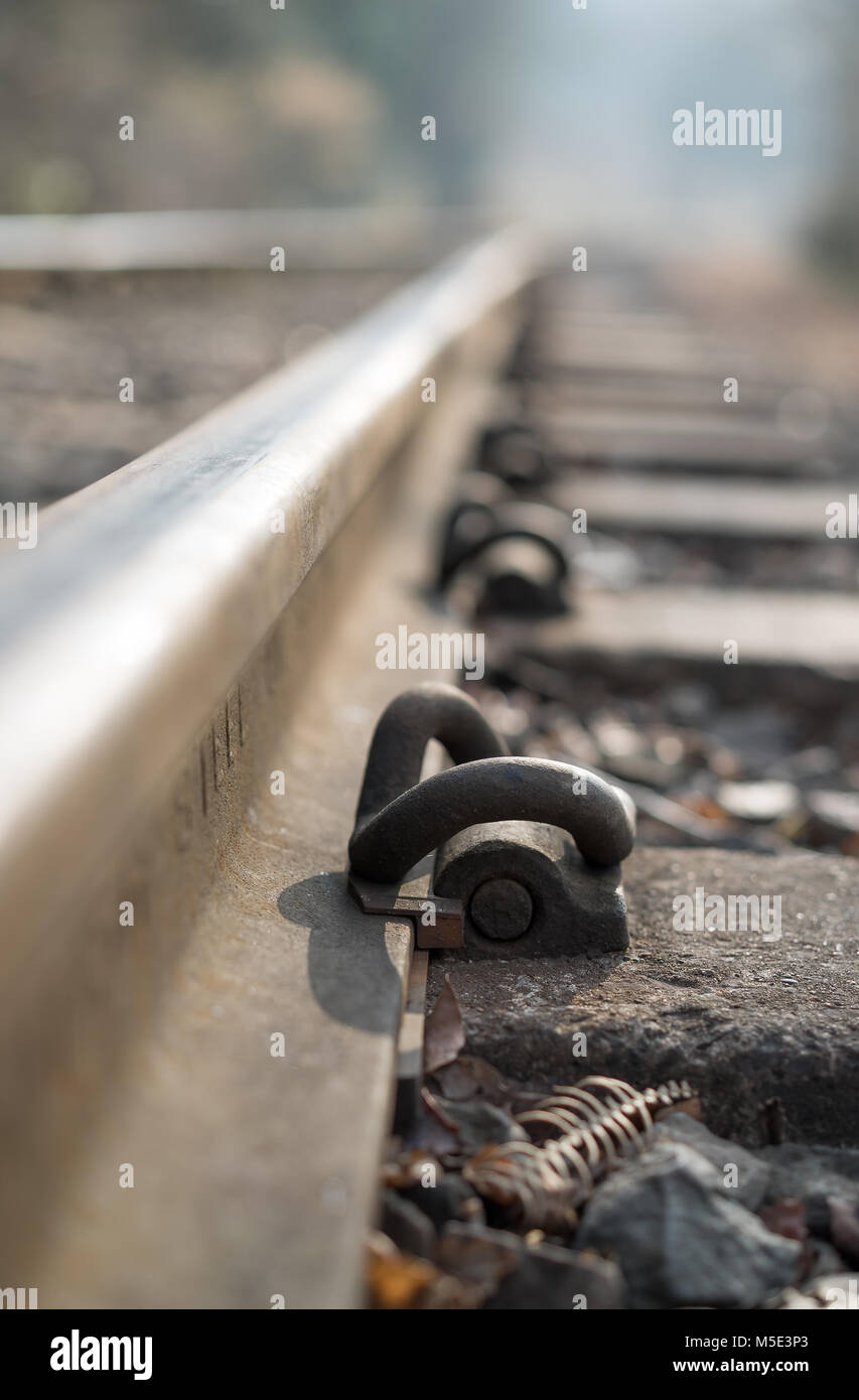 Arty close up of metal fastening system on a railway track. Sharp focus ...