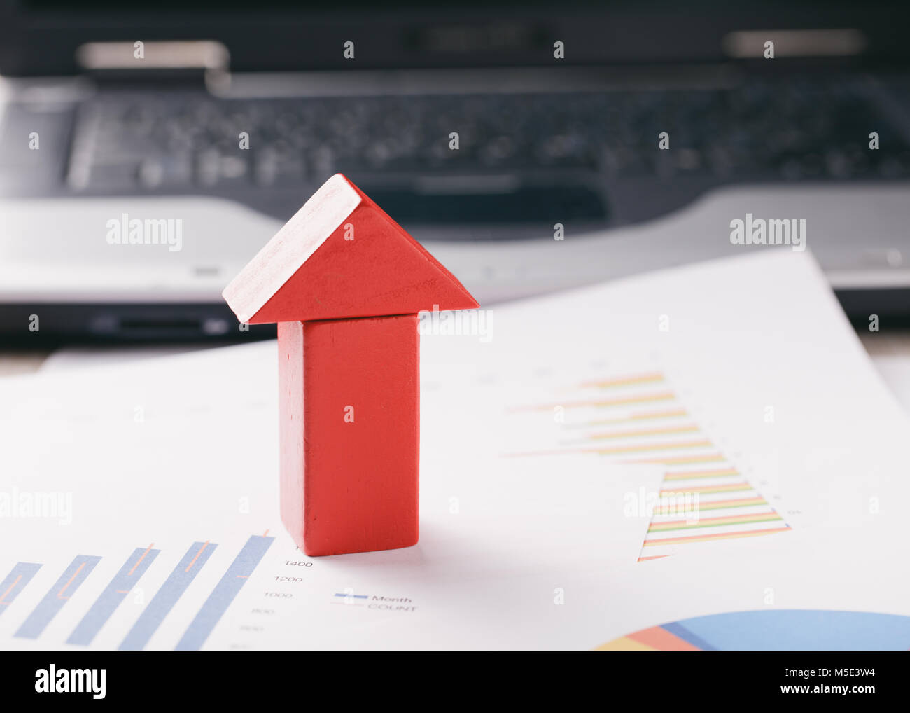 building blocks arrow against blur laptop background Stock Photo - Alamy