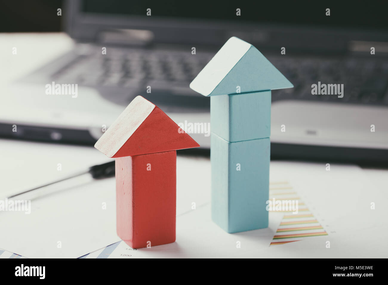 building blocks arrow against blur laptop background Stock Photo - Alamy