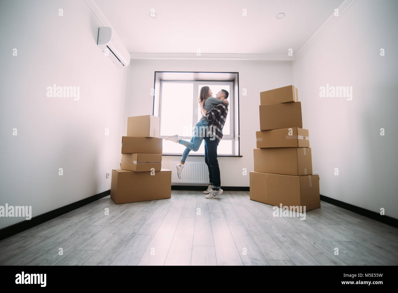 Full length portrait of beautiful young couple hugging and smiling ...