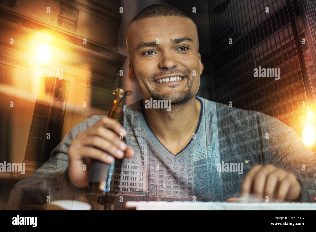Positive portrait of a cheerful person drinking beer and smiling Stock ...