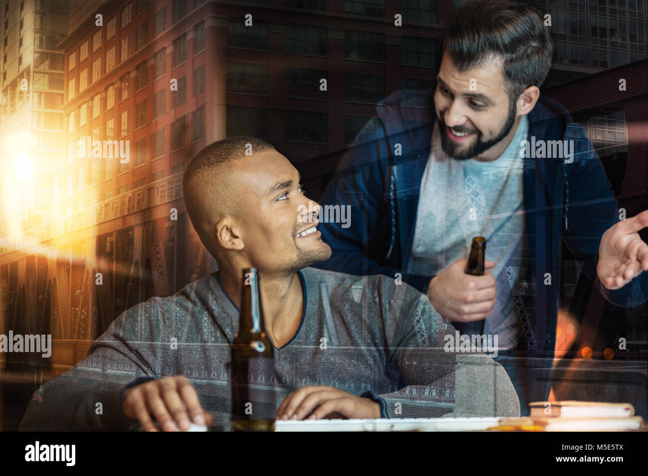 Positive friends having an emotional talk while drinking beer Stock ...