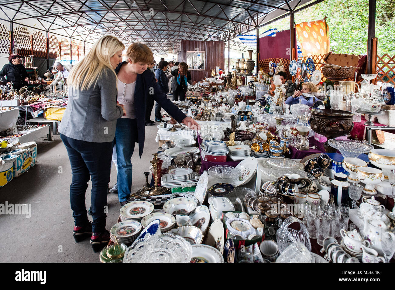 Two customers buying crockery at the Yerevan flea market, Armenia Stock ...