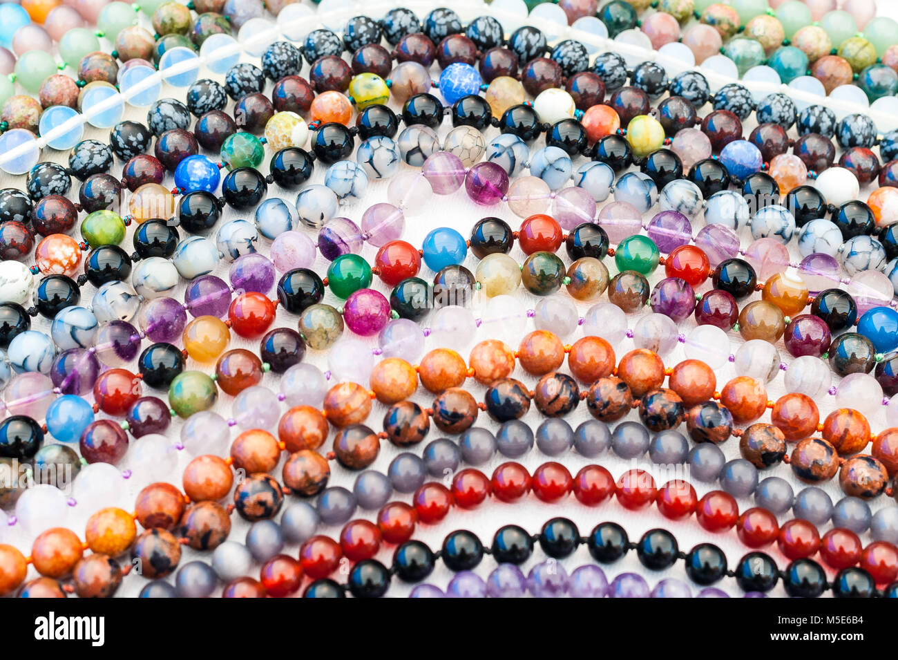 Different colors of beads necklesses Stock Photo - Alamy