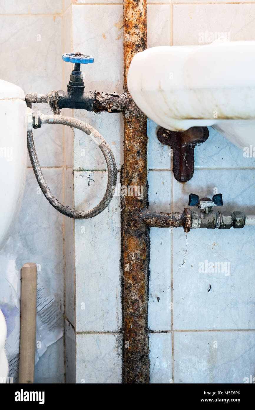 Faucet and old rusty pipes in bathroom Stock Photo - Alamy