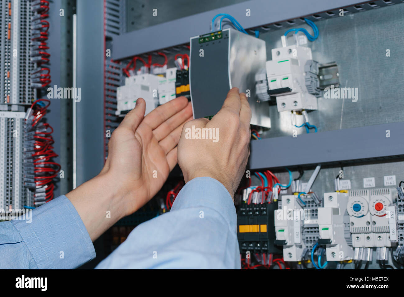 Electrician specialist checking low-voltage cabinet equipment Stock ...