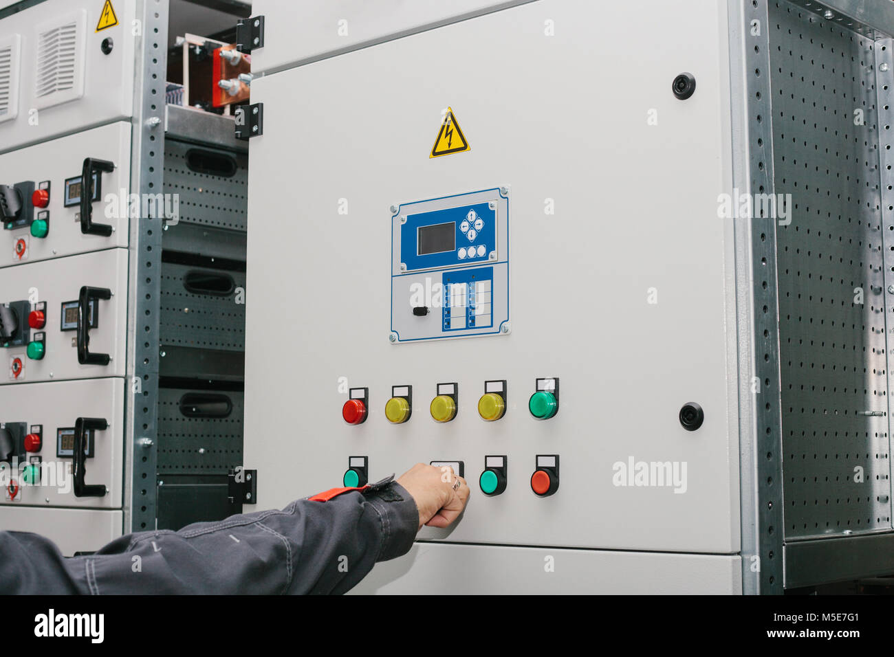 Electrician specialist checking low-voltage cabinet equipment Stock ...