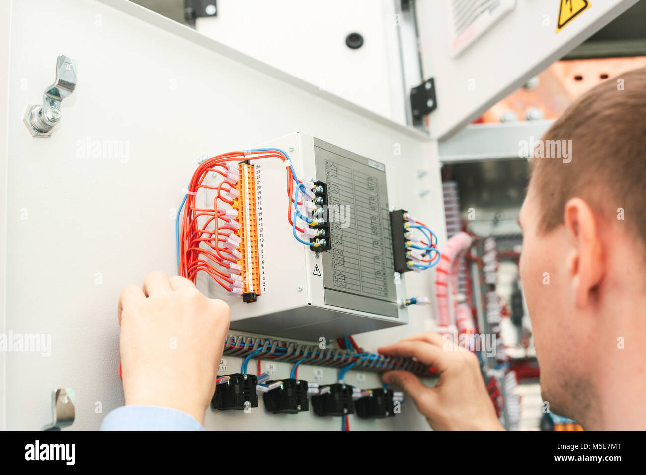 Electrician specialist checking low-voltage cabinet equipment Stock ...