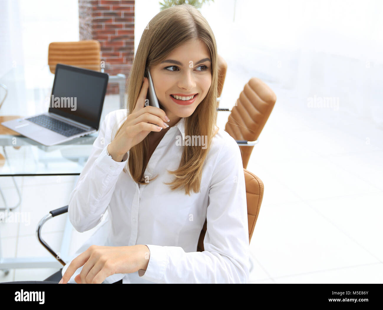 closeup.female assistant talking on mobile phone in office Stock Photo ...