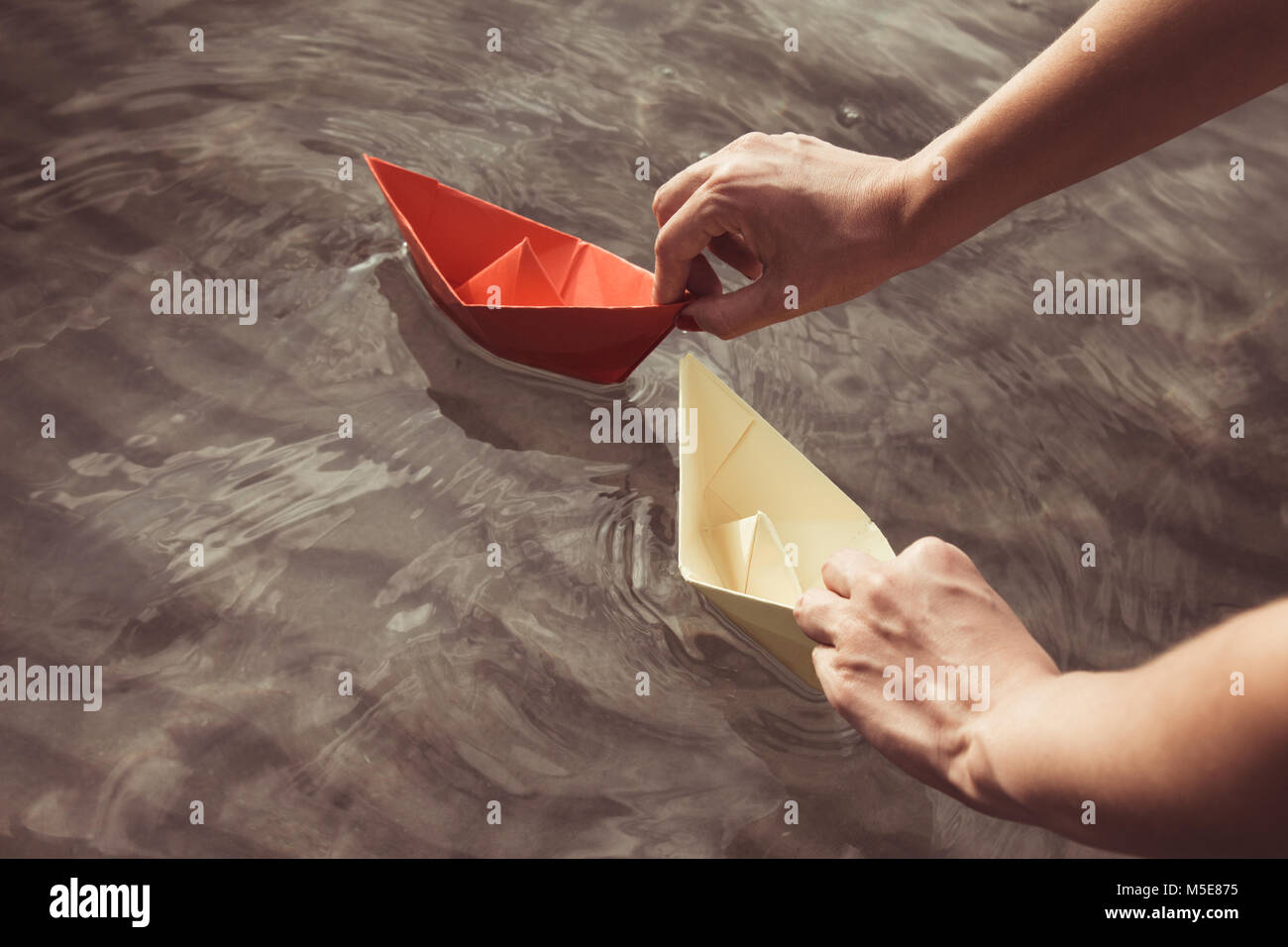 Female floating paper boats Stock Photo - Alamy