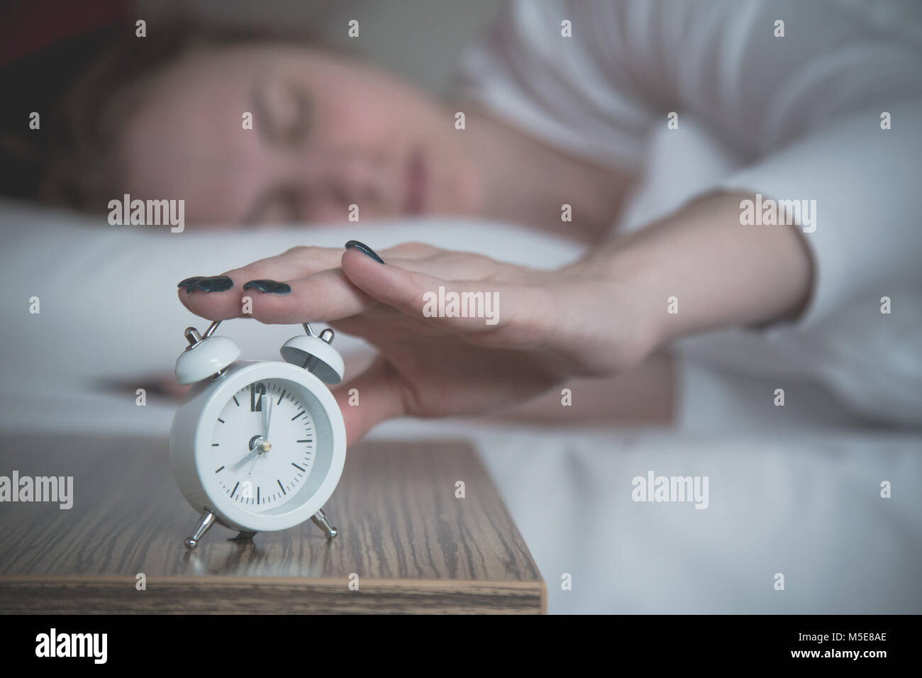 Hand turning off alarm clock hi-res stock photography and images - Alamy
