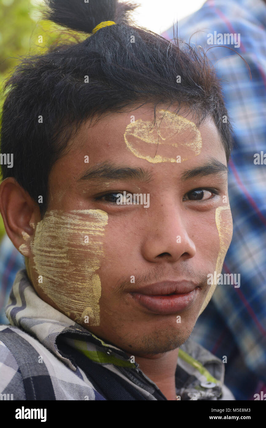 Kyaikto: young man, face with thanaka cosmetic paste, , Mon State ...