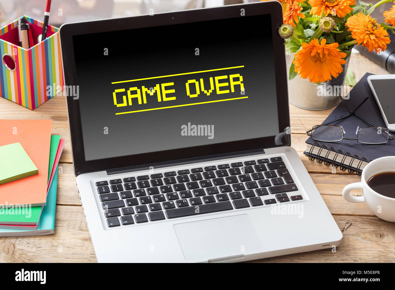 Game over on a computer screen on a wooden office desk Stock Photo - Alamy
