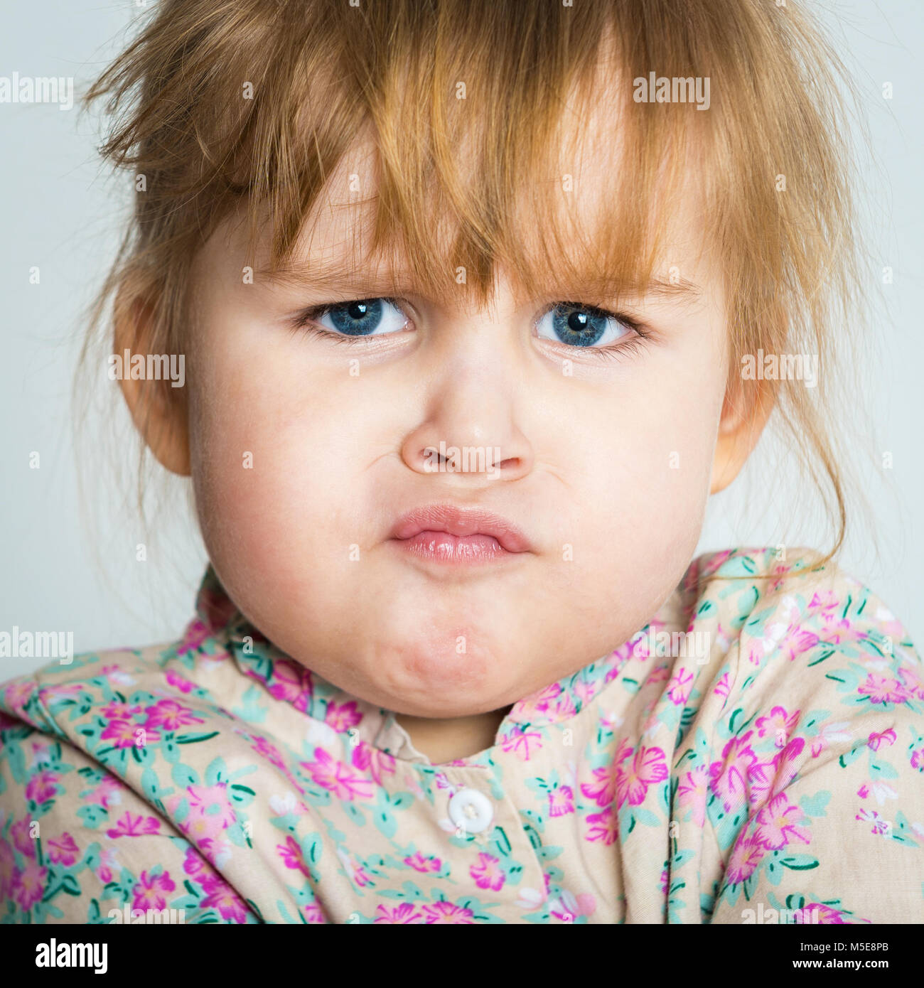 Portrait of a little angry girl. Photo closeup Stock Photo - Alamy